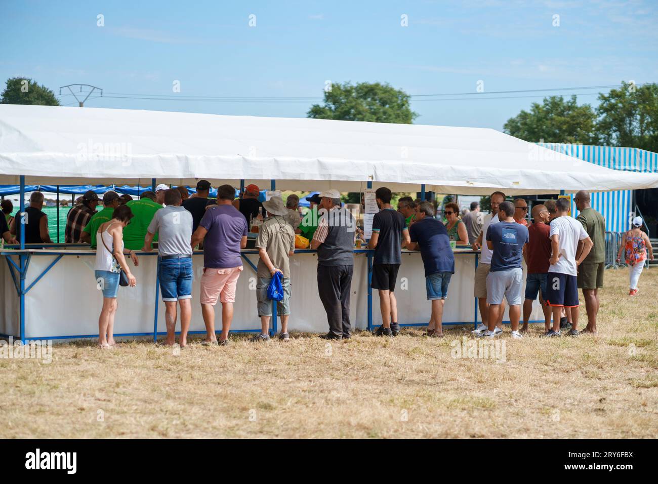 Farmers gather around the bar at a harvest festival Stock Photo - Alamy