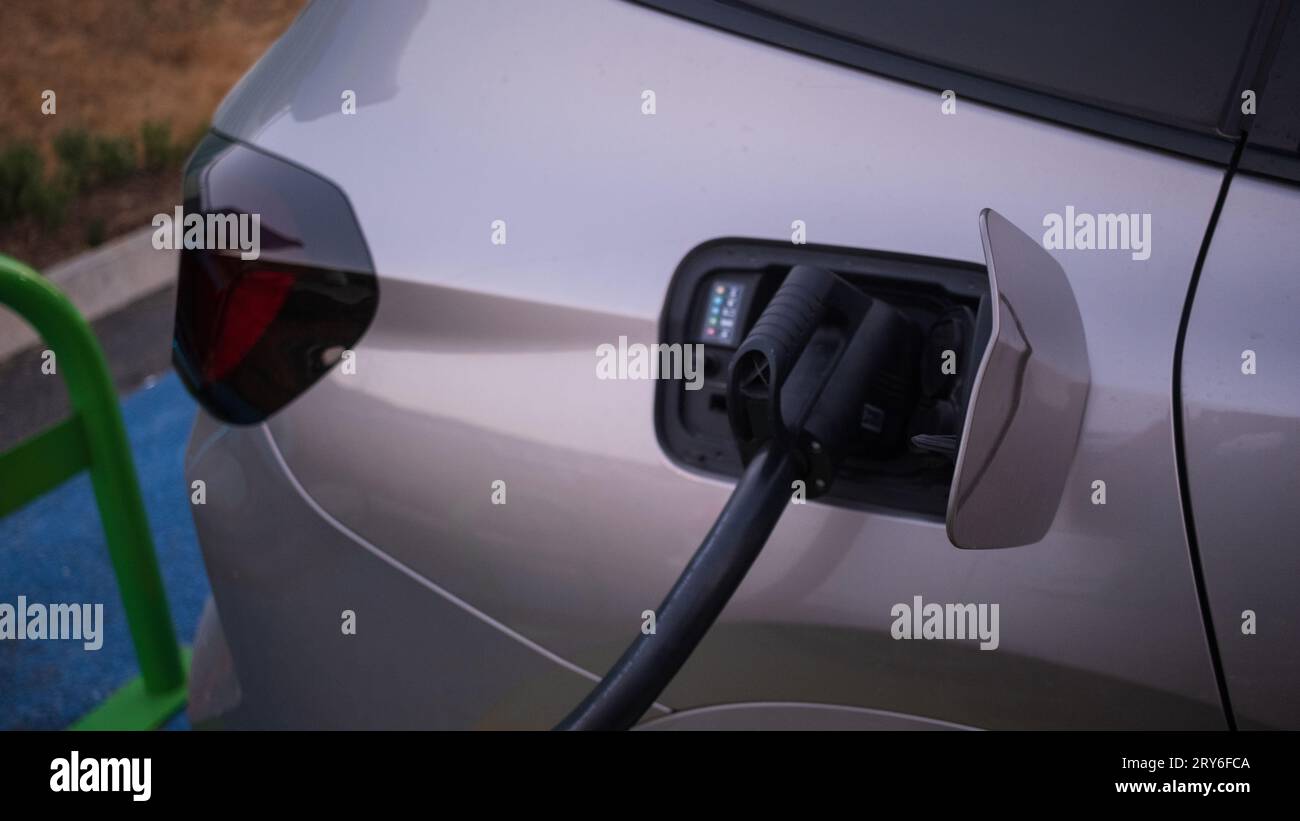 Power cable pump plug in charging power to electric vehicle EV car with ...