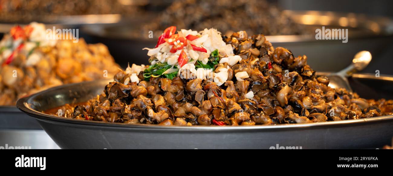 Stir-fried spicy flavored snail meat, delicious traditional street food ...