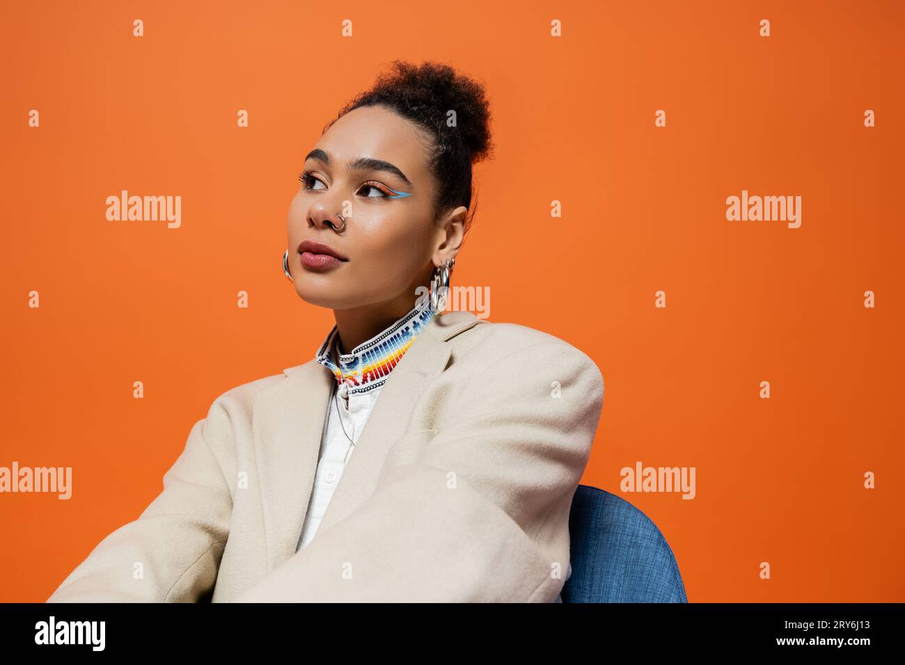 beautiful young model in chic street clothing vibrant makeup and hoop ...