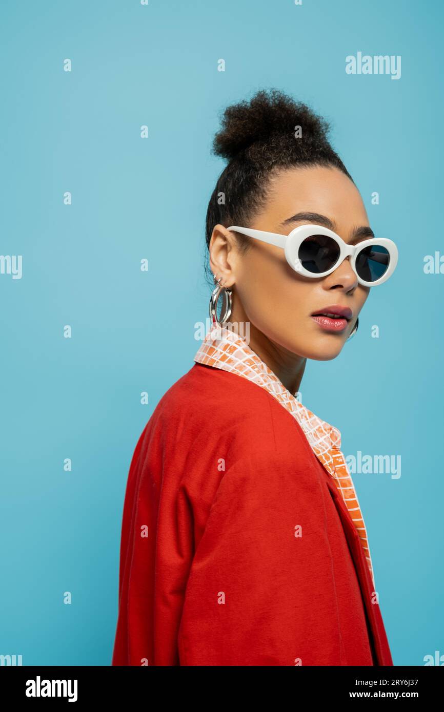 eye-catching african american model in vibrant outfit and sunglasses on ...