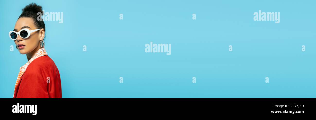 eye-catching african american model in vibrant outfit and sunglasses on ...