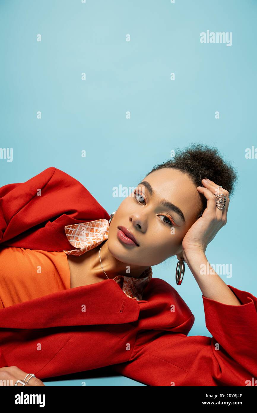 attractive african american model in silver accessories and vibrant ...