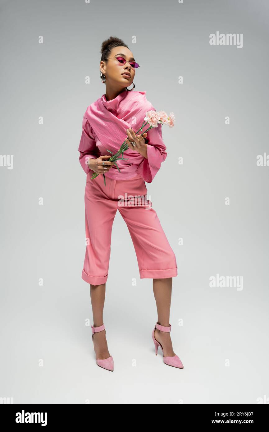 expressive african american fashion model in pink attire and heels ...