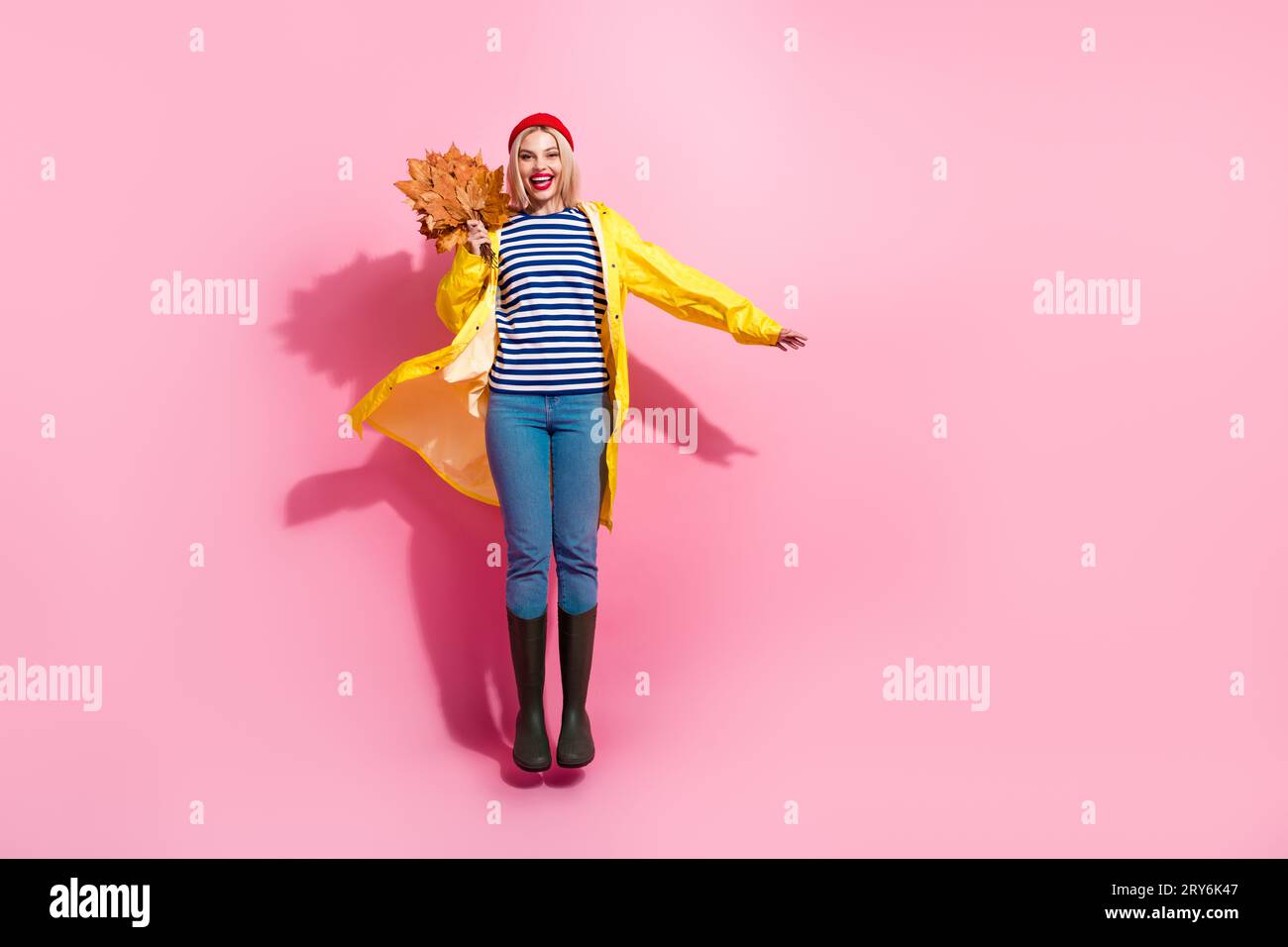 Full length photo of excited funky woman dressed rain coat jumping high ...