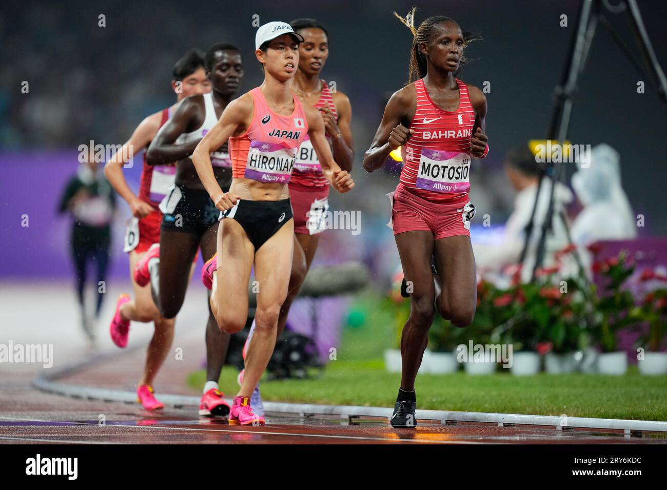 Japan's Ririka Hironaka, left, competes with Bahrain's Violah Jepchumba ...