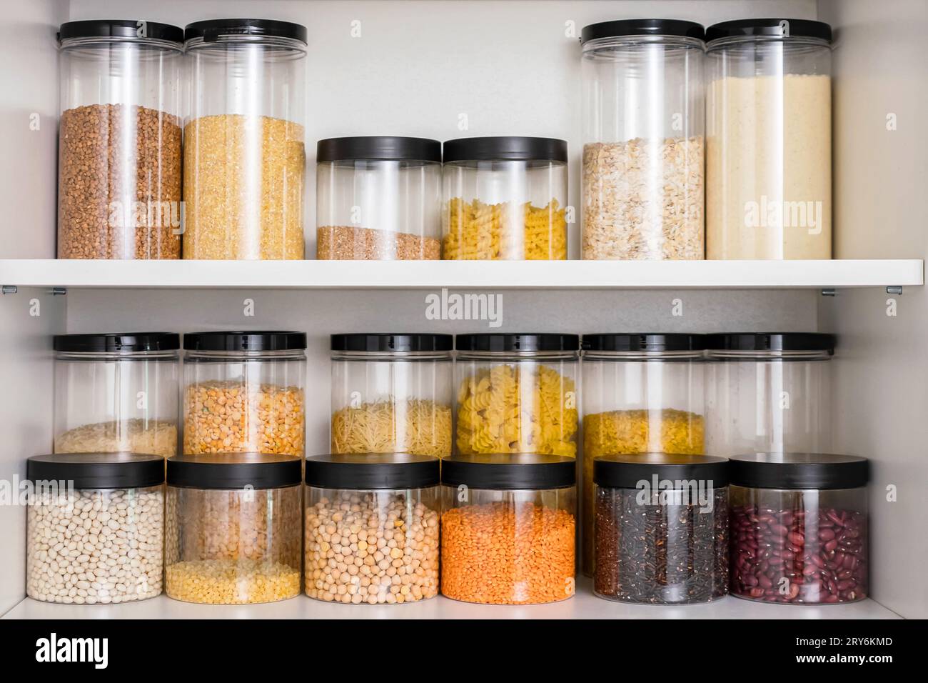Stored containers with grains and pasta in kitchen cabinet Stock Photo ...