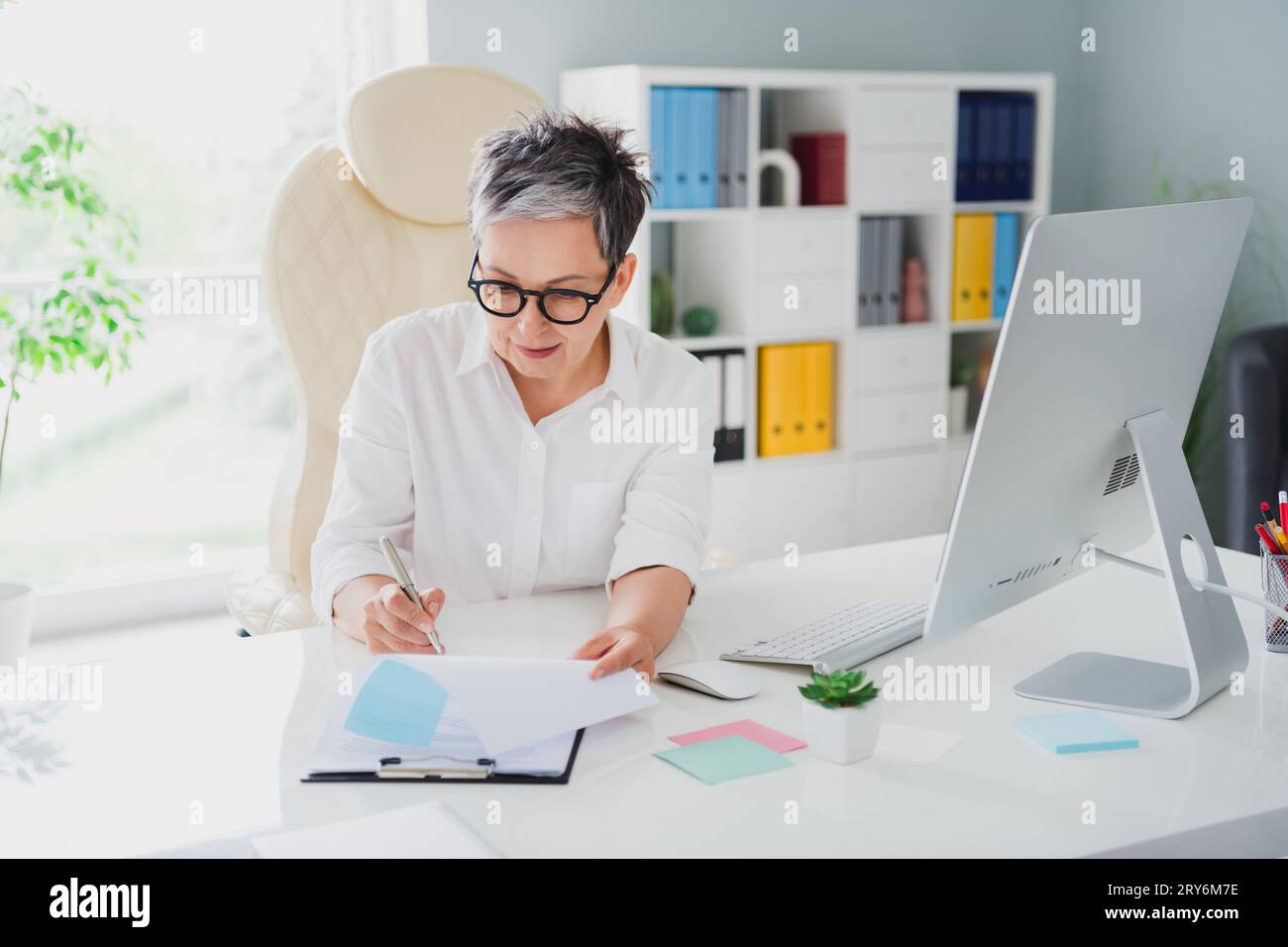 Photo attractive confident financial boss write signature documents ...