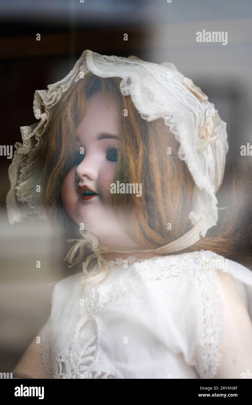 Antique doll in a shop window Stock Photo - Alamy