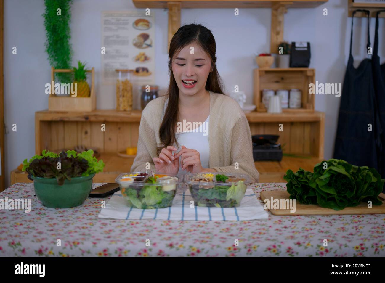 Pretty woman is livestreaming for sell healthy food. Vlogging and ...