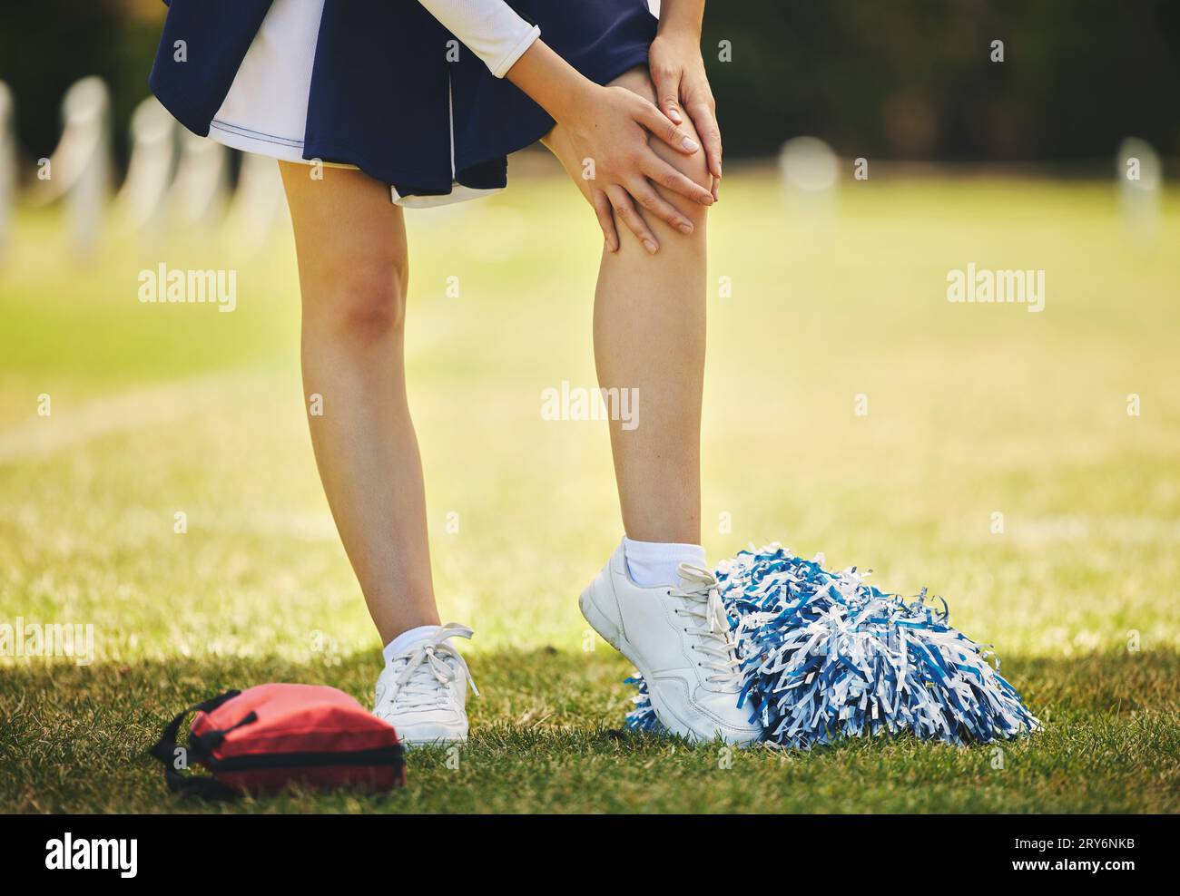 Cheerleader, injury and person with knee pain from sport, training and ...