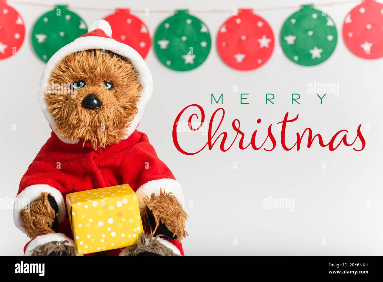 Funny teddy bear in Santa Claus suit with Christmas present Stock Photo ...