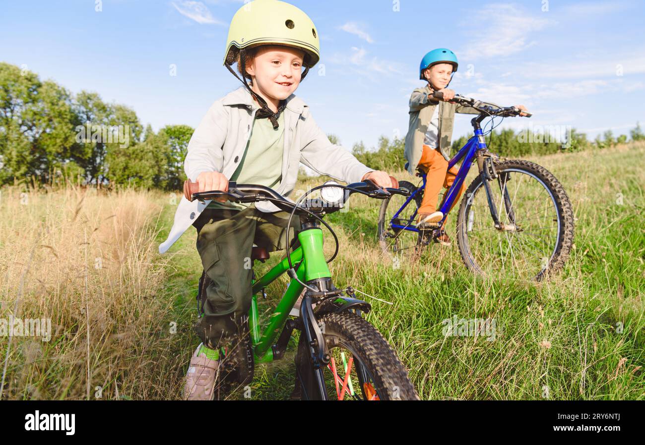 Happy children riding bicycles in countryside on Autumn day Stock Photo ...