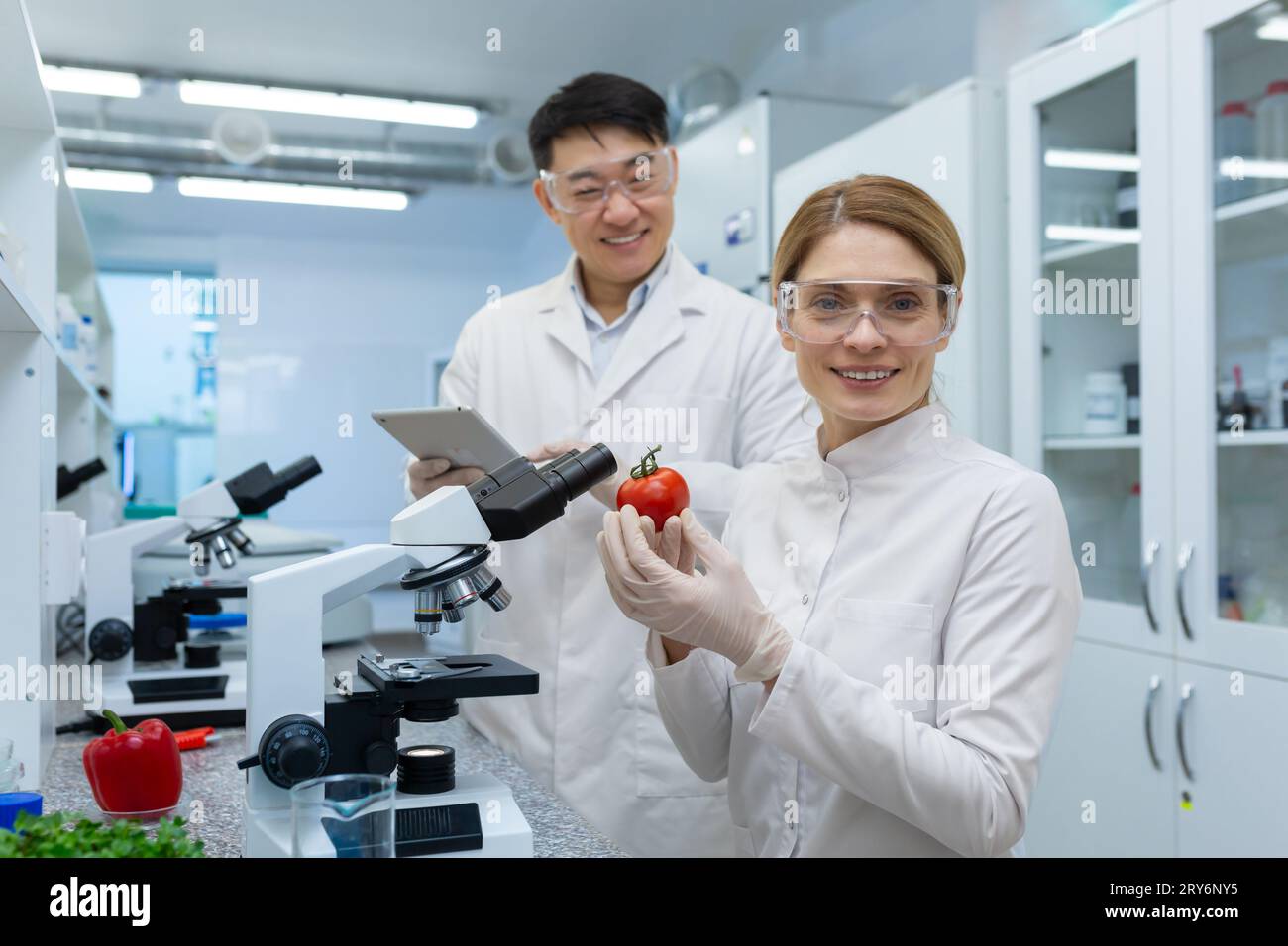 Research of food products in the laboratory. Young specialists Asian ...