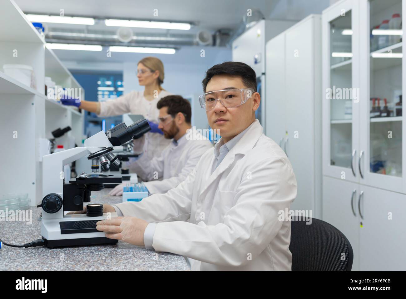 A group of young medical students and scientists are studying in the ...