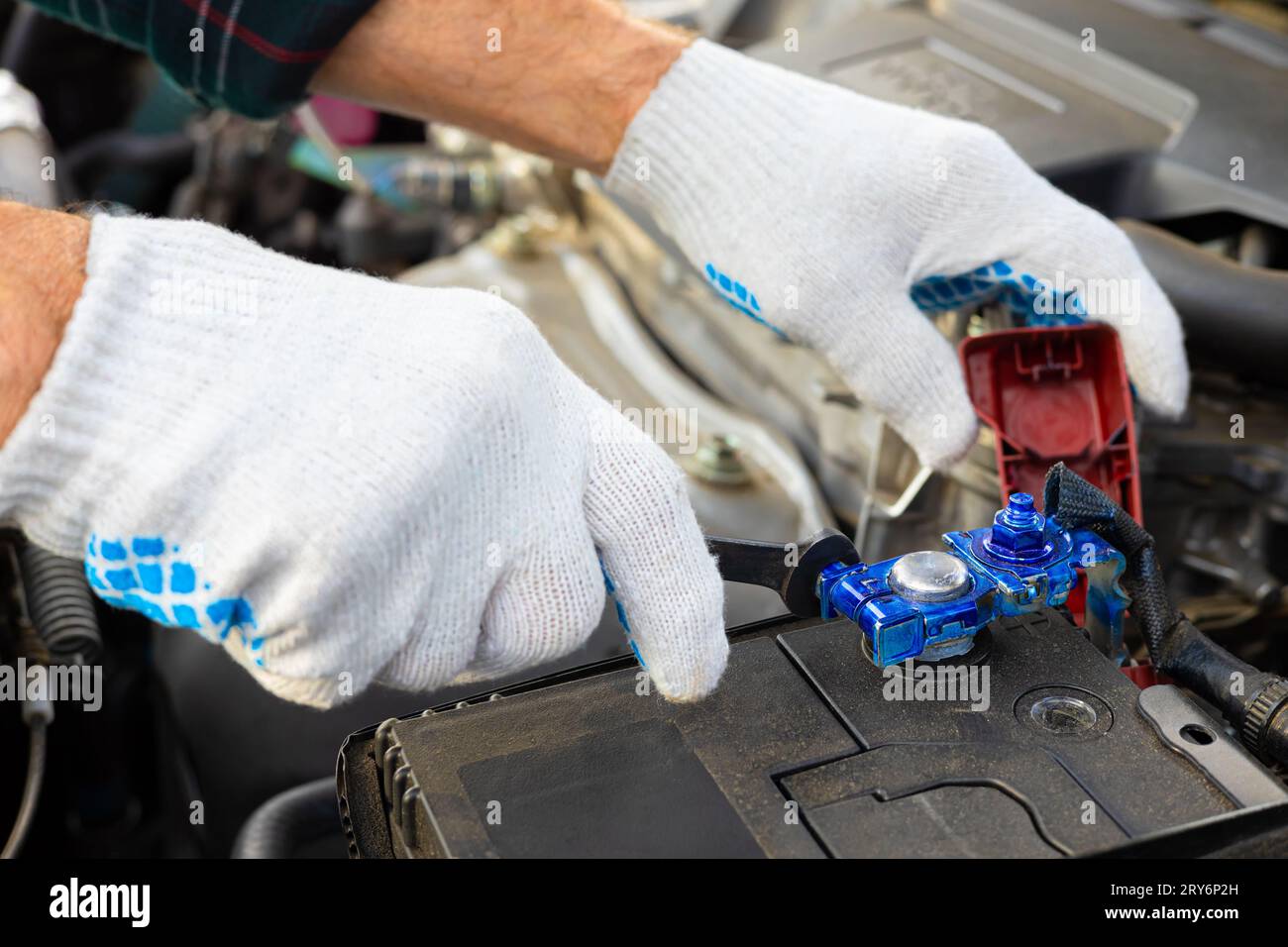 the driver is replacing the car battery. battery terminal installation ...