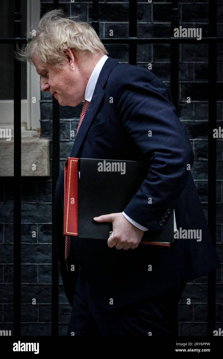 British Prime Minister Boris Johnson looks down as he exits No 10 ...