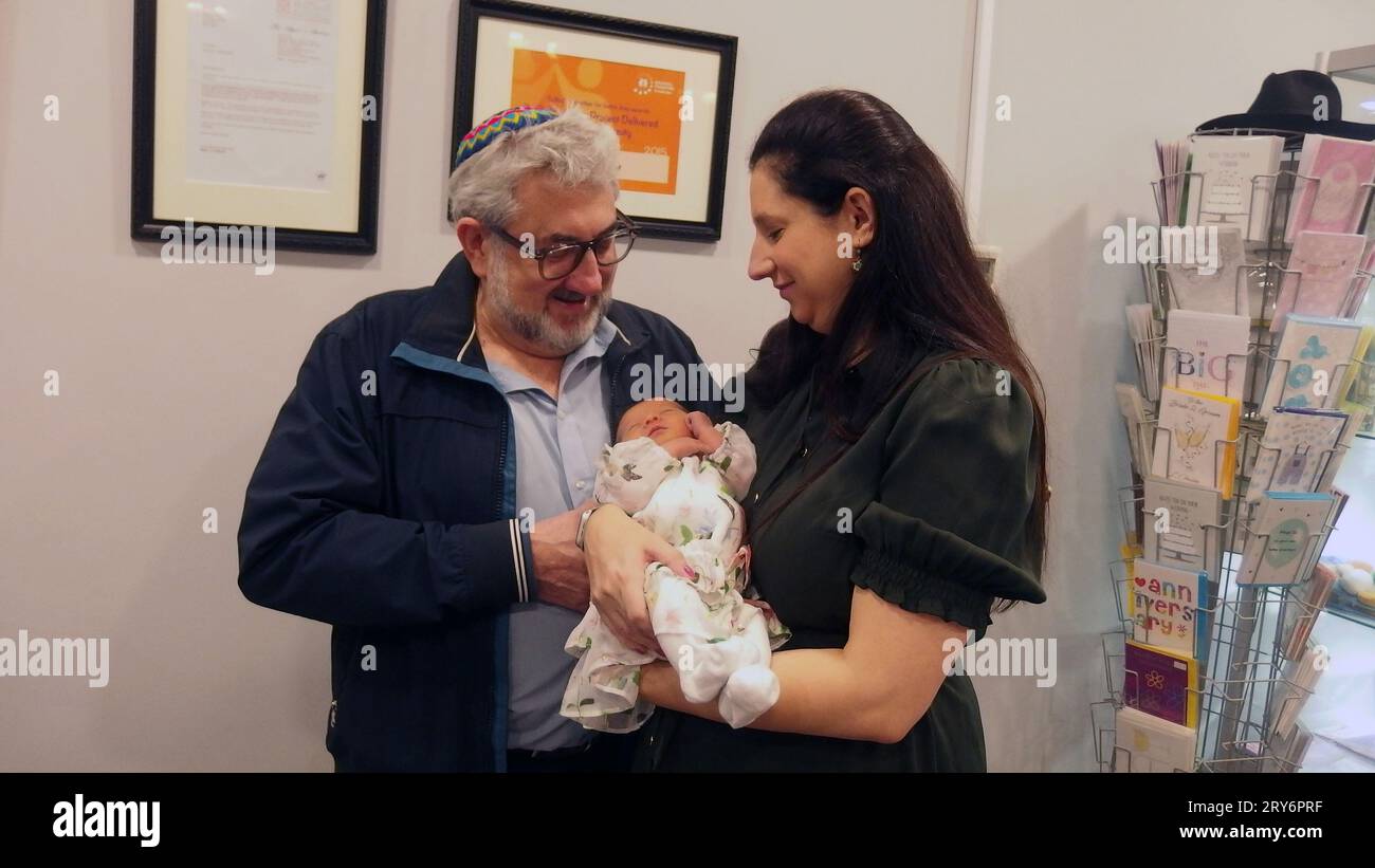 A grandfather is called up to read the Torah by the rabbi during a ...