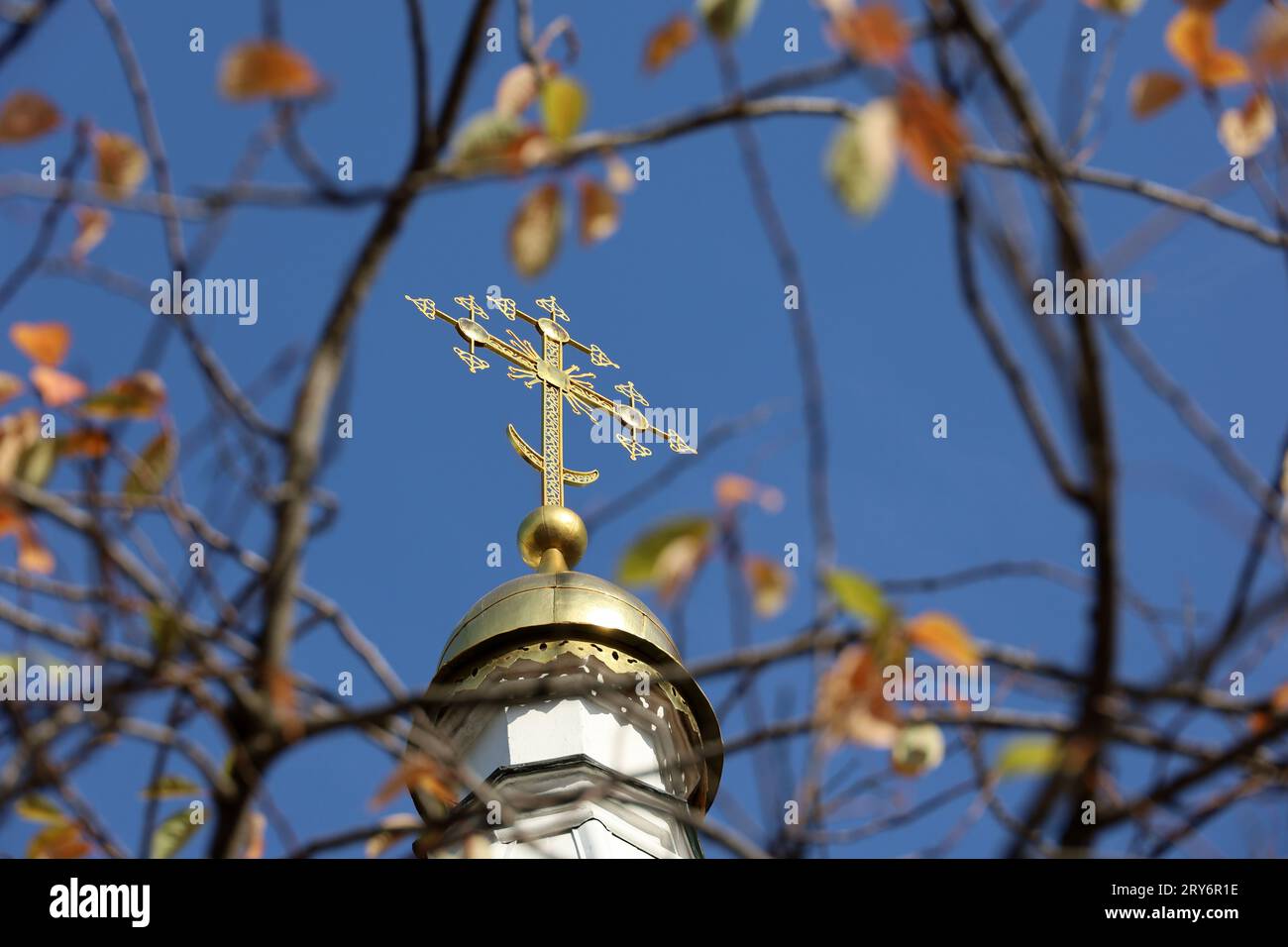 View through the autumn tree to temple of the Orthodox Church. Old ...