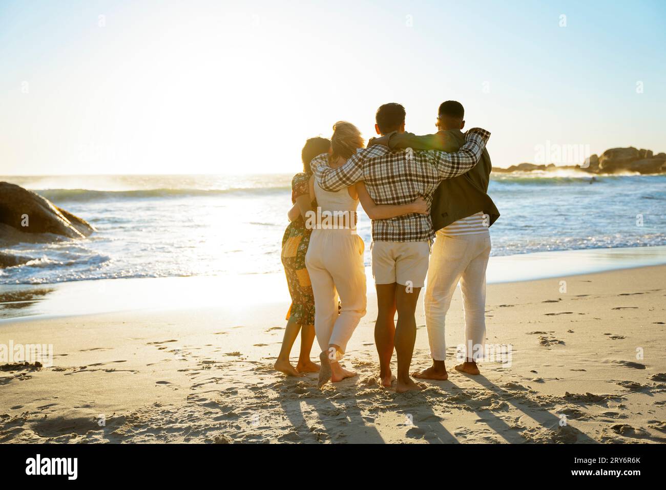 Four Friends Watching the Ocean Stock Photo - Alamy