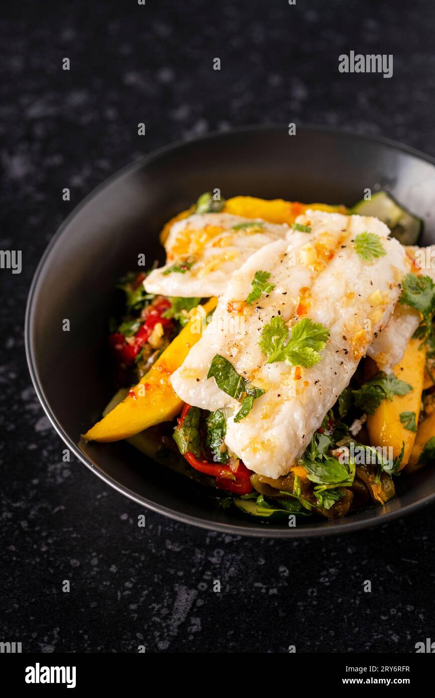 Thai fish and mango salad Stock Photo - Alamy