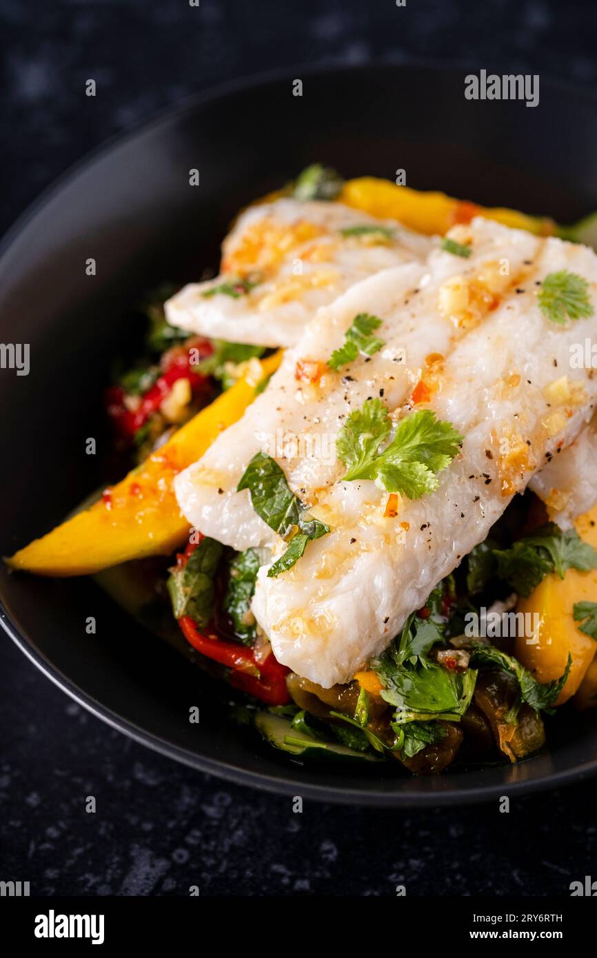 Thai fish and mango salad Stock Photo - Alamy