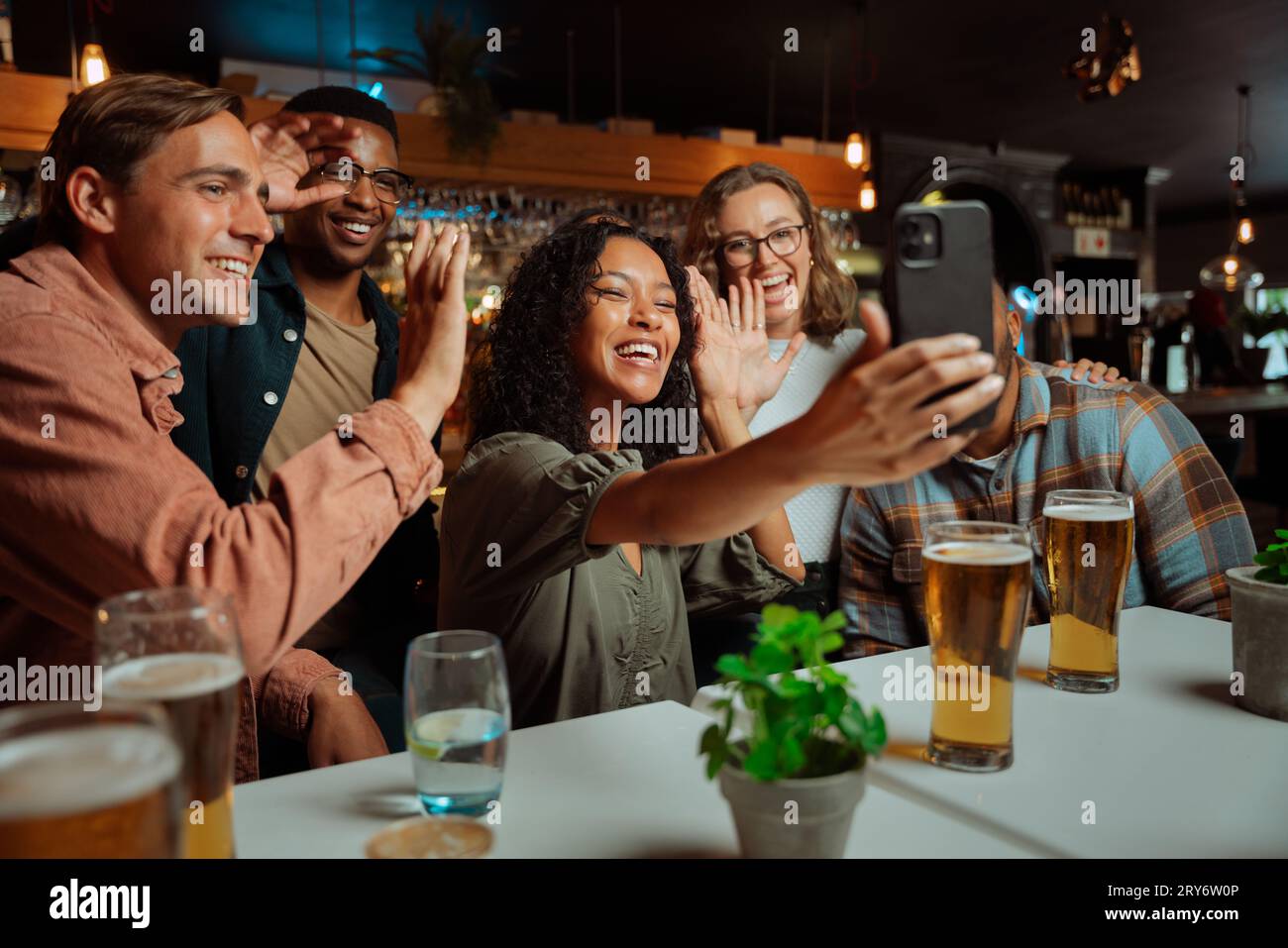Diverse friends waving to camera hi-res stock photography and images ...