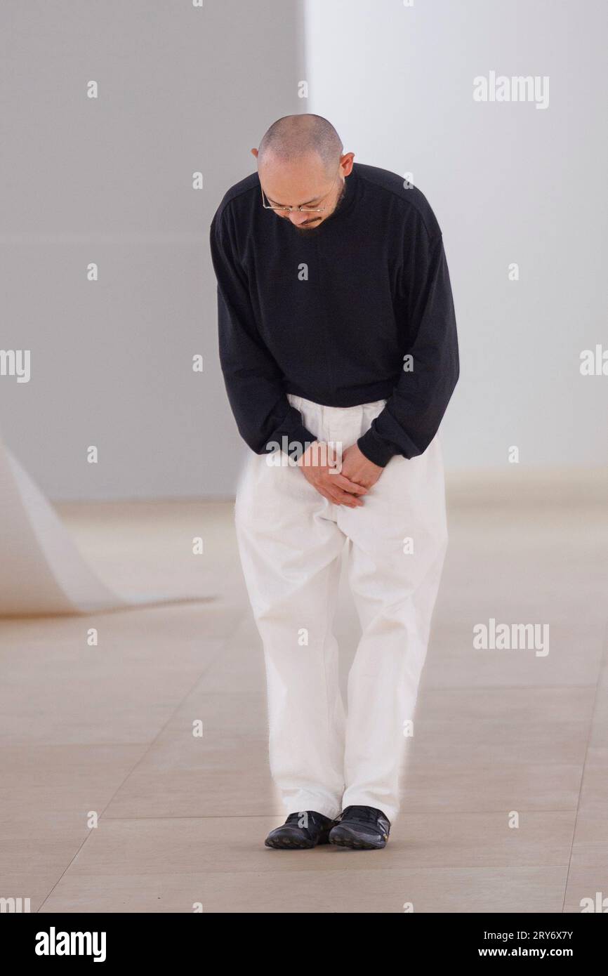 Fashion designer Satoshi Kondothe acknowledges applause following the ...