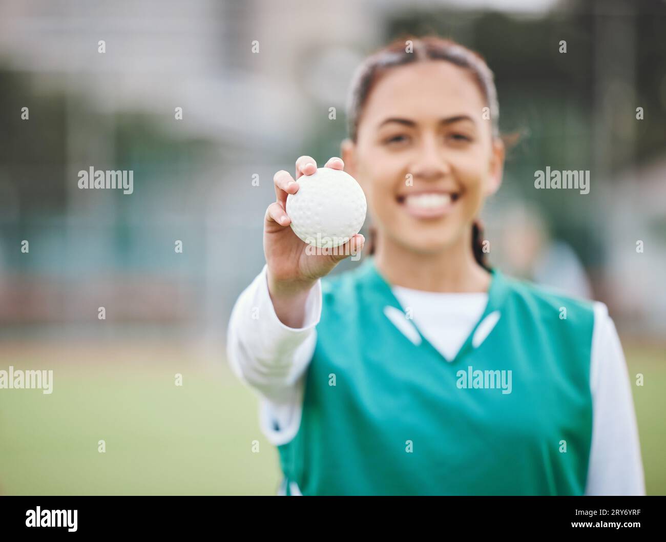 Female, person and smile for hockey with ball in hand on field for ...