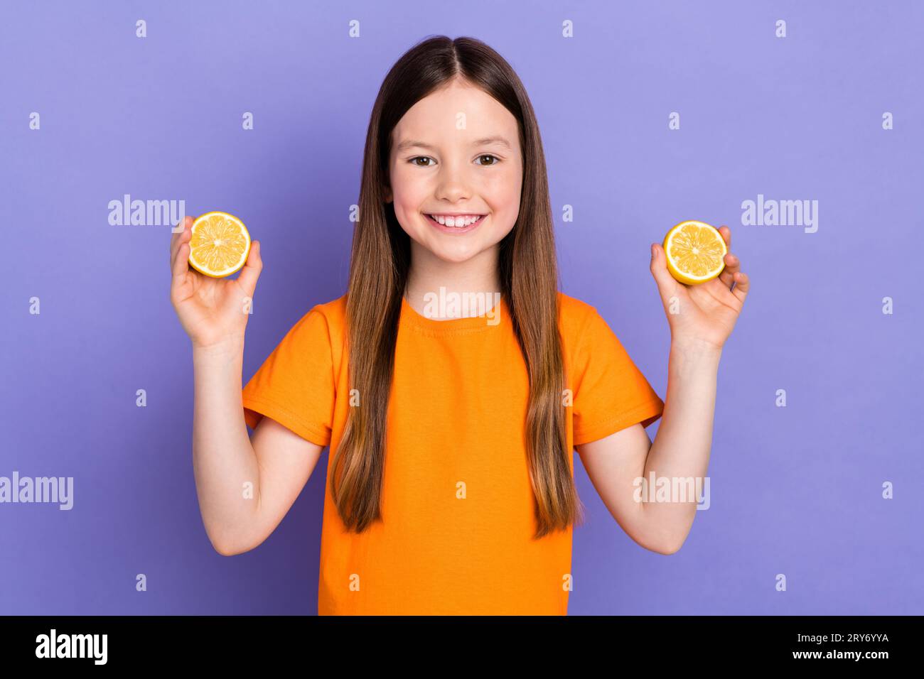 Portrait of cute daughter small girl school kid holding two citrus lime ...