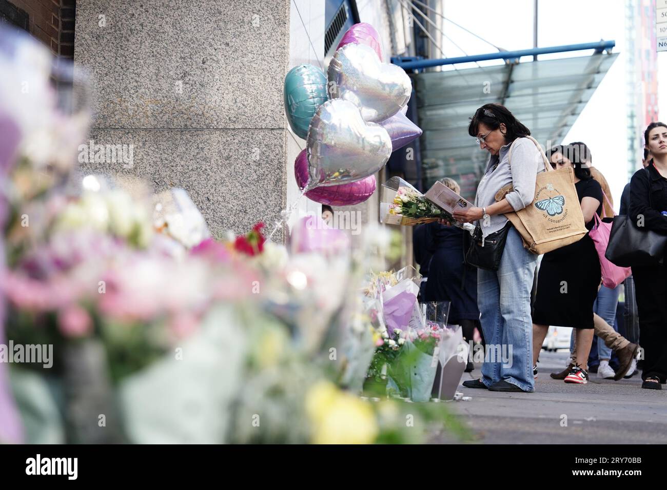 People laying flowers near the scene in Croydon, south London, where 15 ...