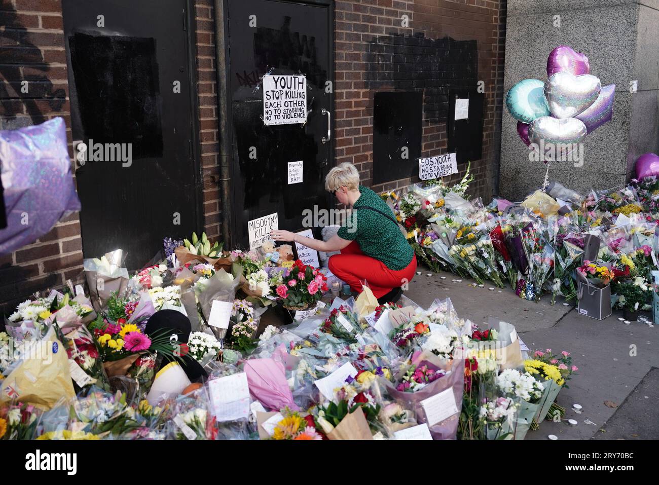 People laying flowers near the scene in Croydon, south London, where 15 ...