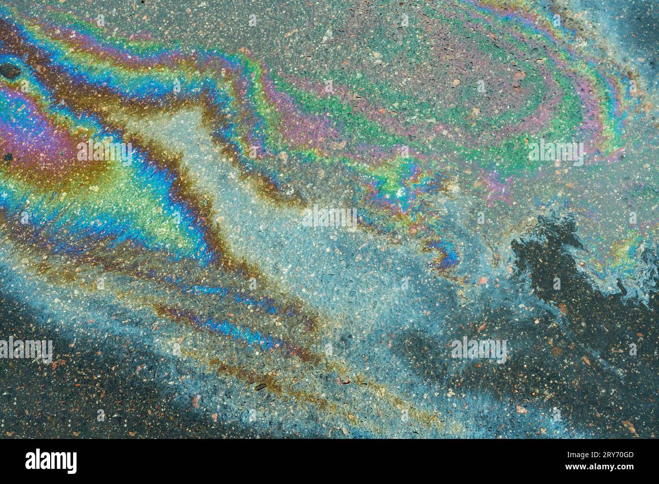 Colored oil stains close up, the color of the gasoline stain on the ...
