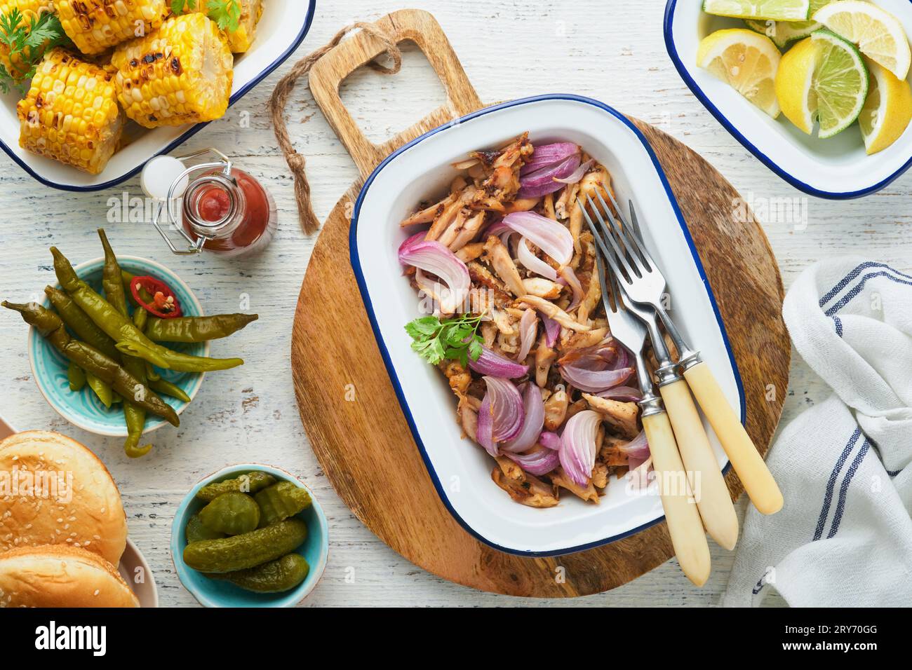Pulled bbq chicken with baked onions on serving platter, bbq corn ...
