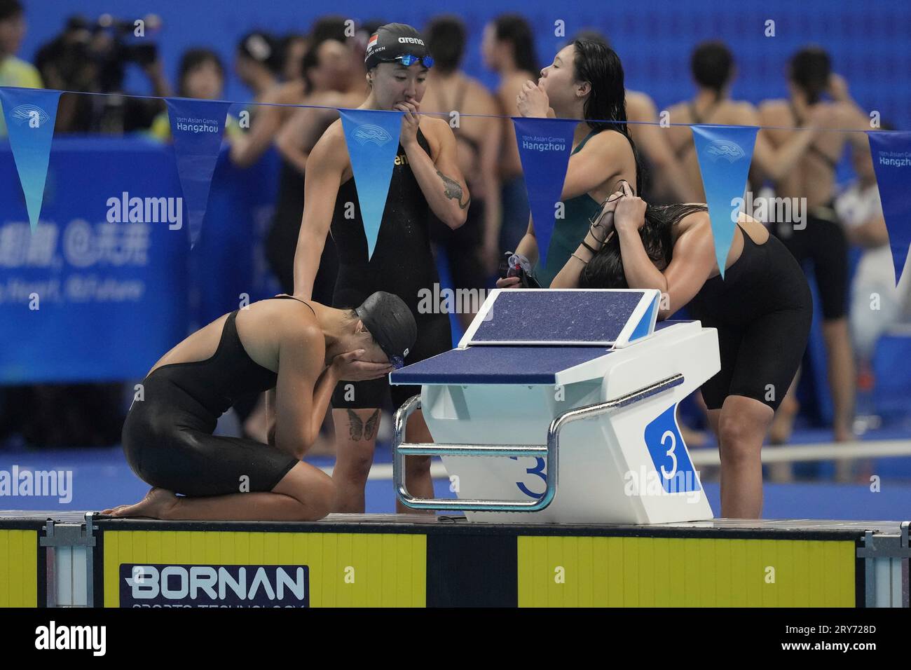 Team Singapore reacts after being disqualified from the women's 4x100m ...