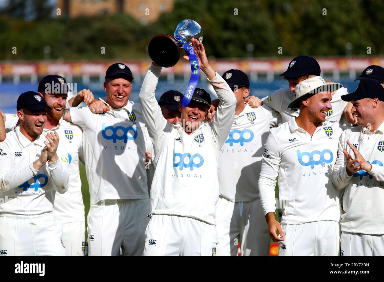 Durham captain Scott Borthwick (centre) lifts the trophy as he ...