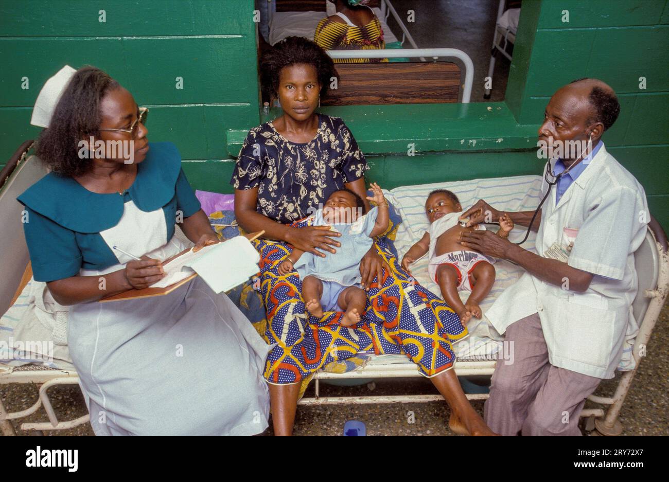 Ghana, Mother and twin babies with nurse and doctor in clinic of ...