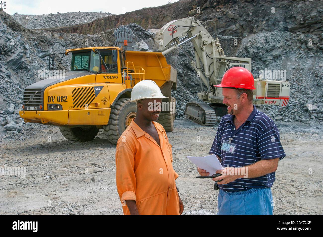 Ghana, Tarkwa. Overview of open pit with a manager of the mining ...