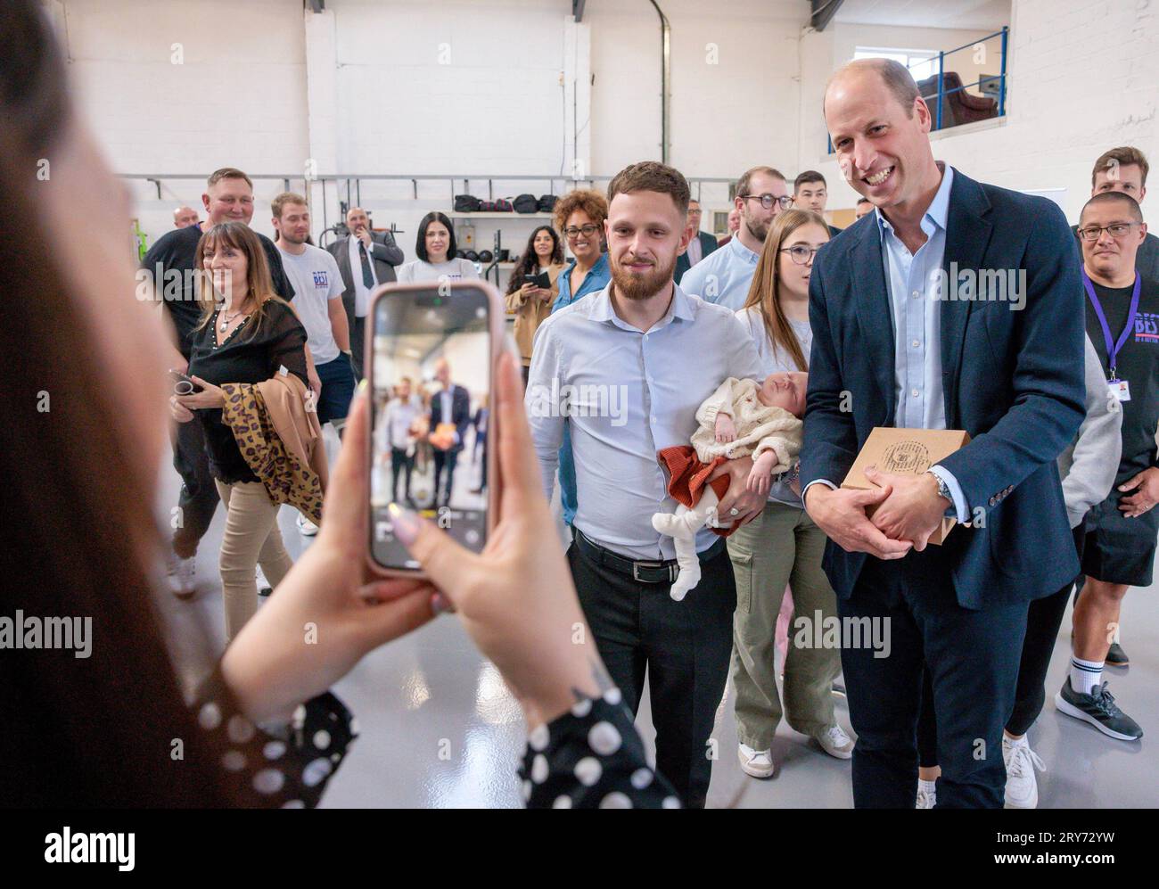 The Prince of Wales (right) poses with baby Layla Bryden and her father ...