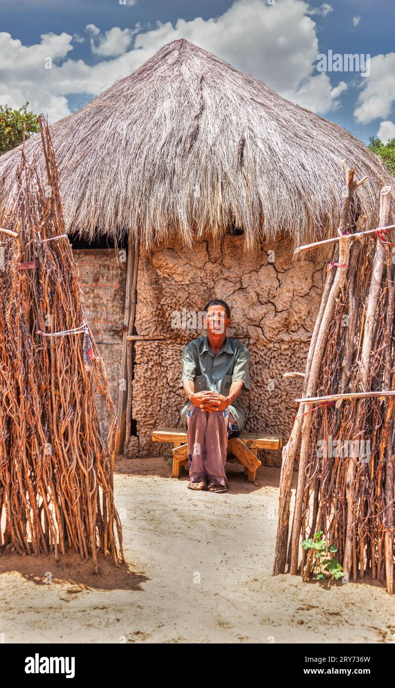 San people or Bushmen, in front of his house, they are the members of ...