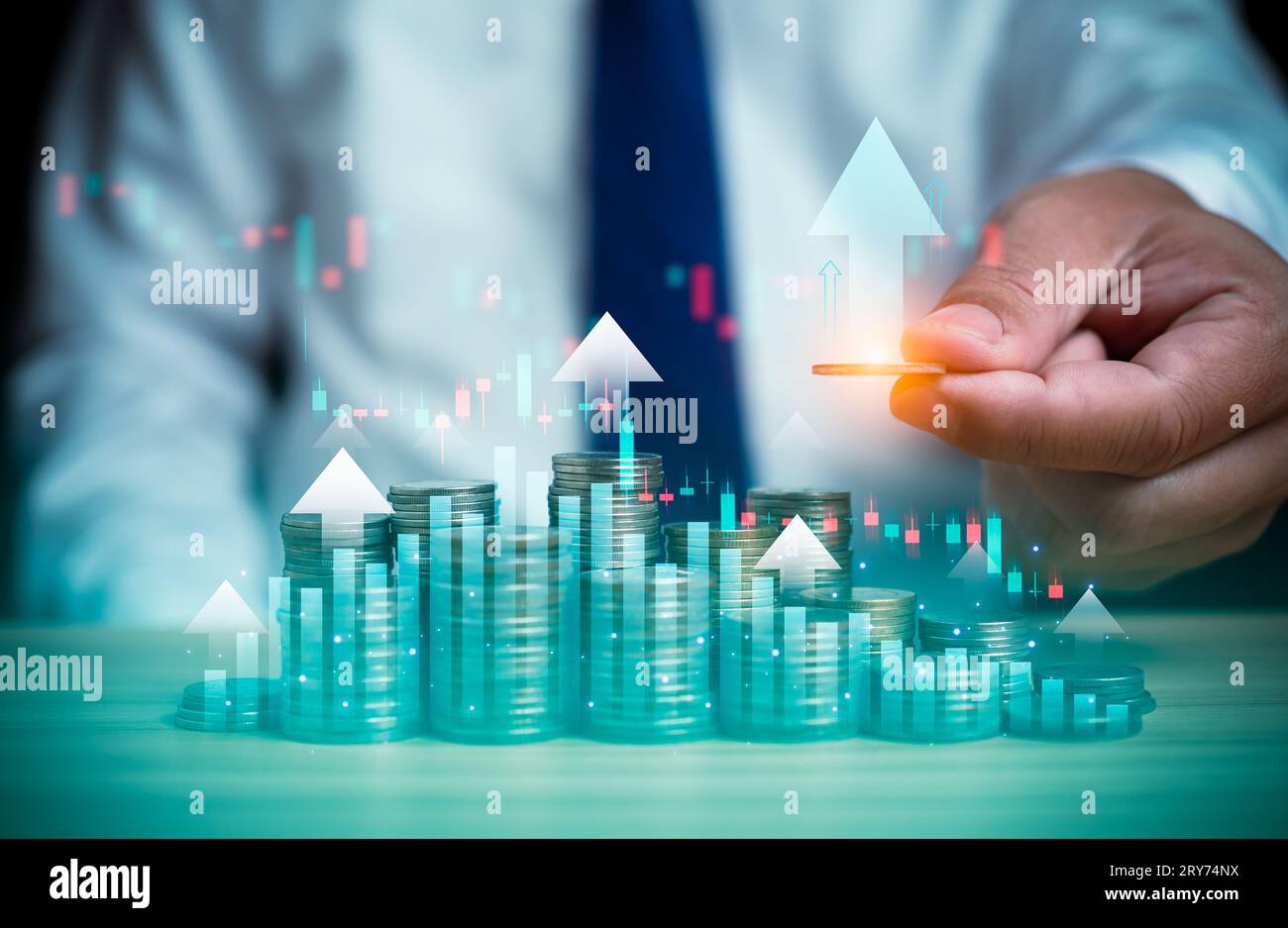 Businessman puts money on pile of coins. Ideas for investing and ...