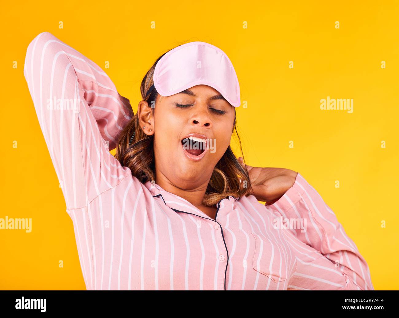 Wake up, yawn and a woman on a yellow background in pyjamas for ...