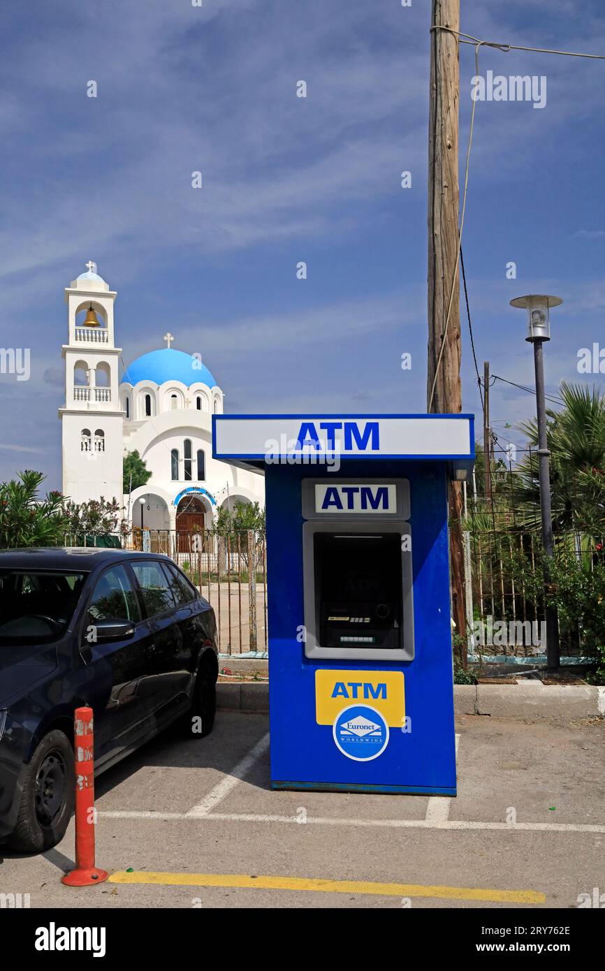 ATM cash machine and Church of Agioi Anargyroi and bell tower, Skala ...
