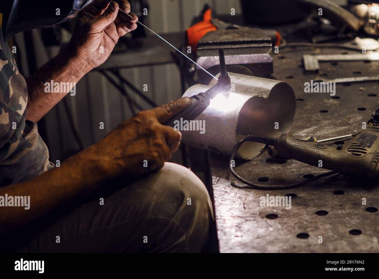 Industrial welder worker welding using argon machine, close up. Male in ...