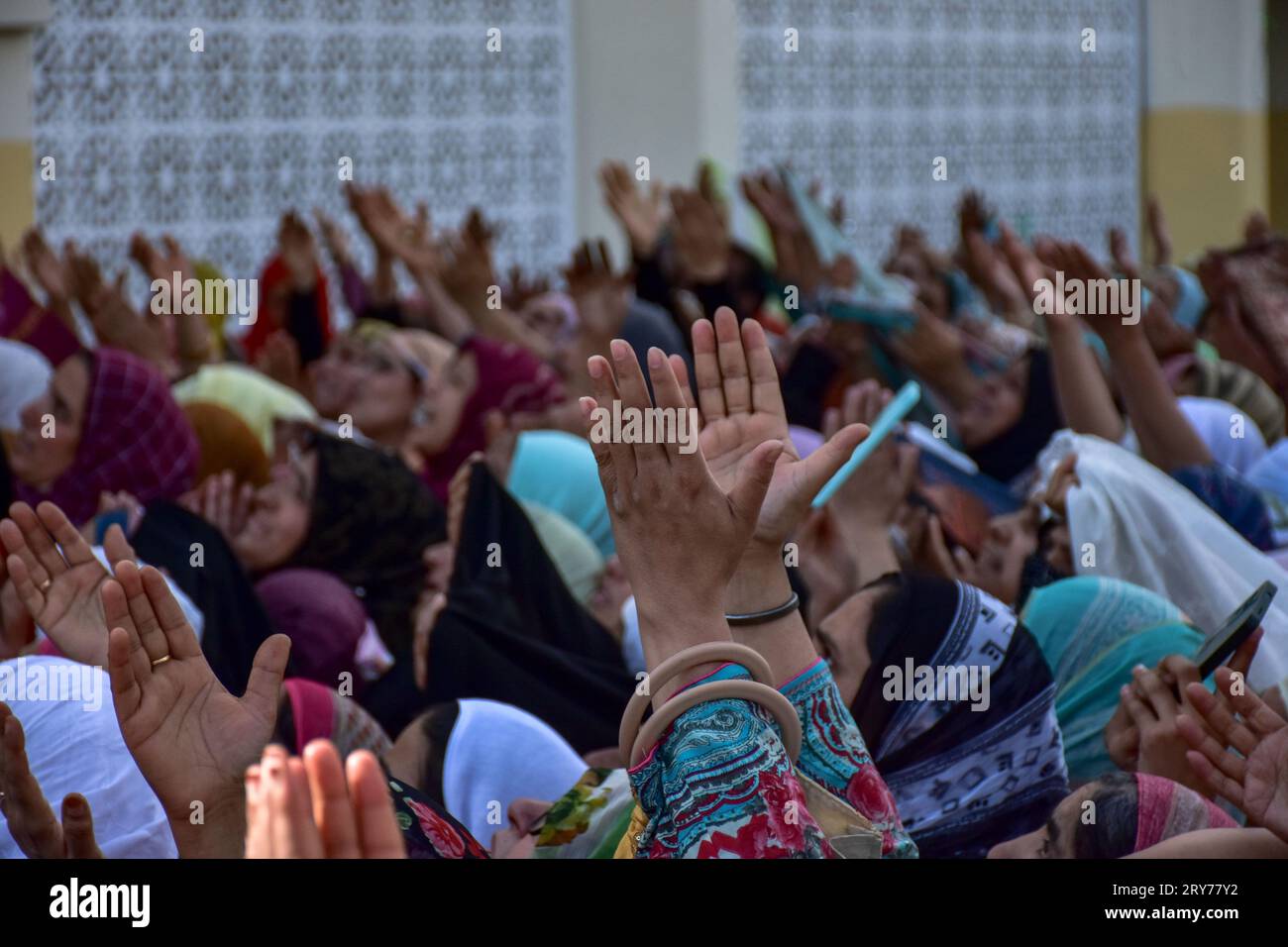 A Kashmiri Muslim woman raises her hands as she prays on the occasion ...