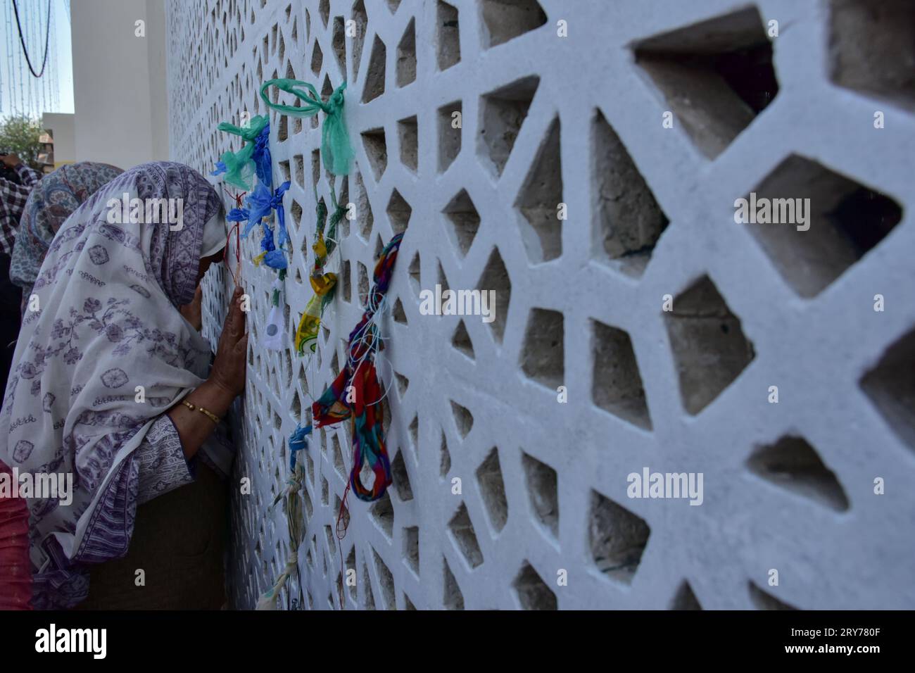 A Kashmiri woman prays on the occasion of Eid-e-Milad, the birth ...
