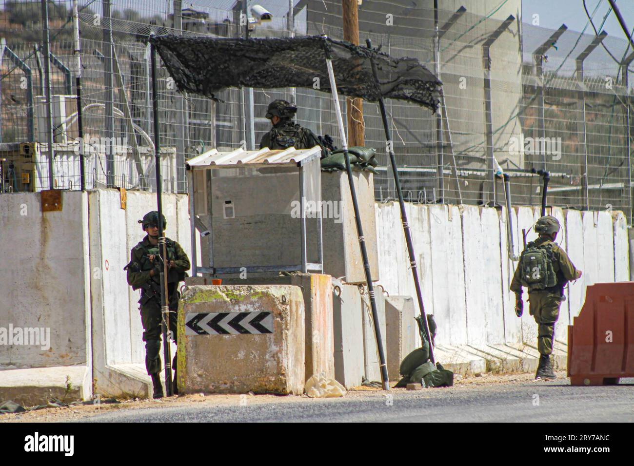 Israeli soldiers stand alert around an Israeli checkpoint near the ...