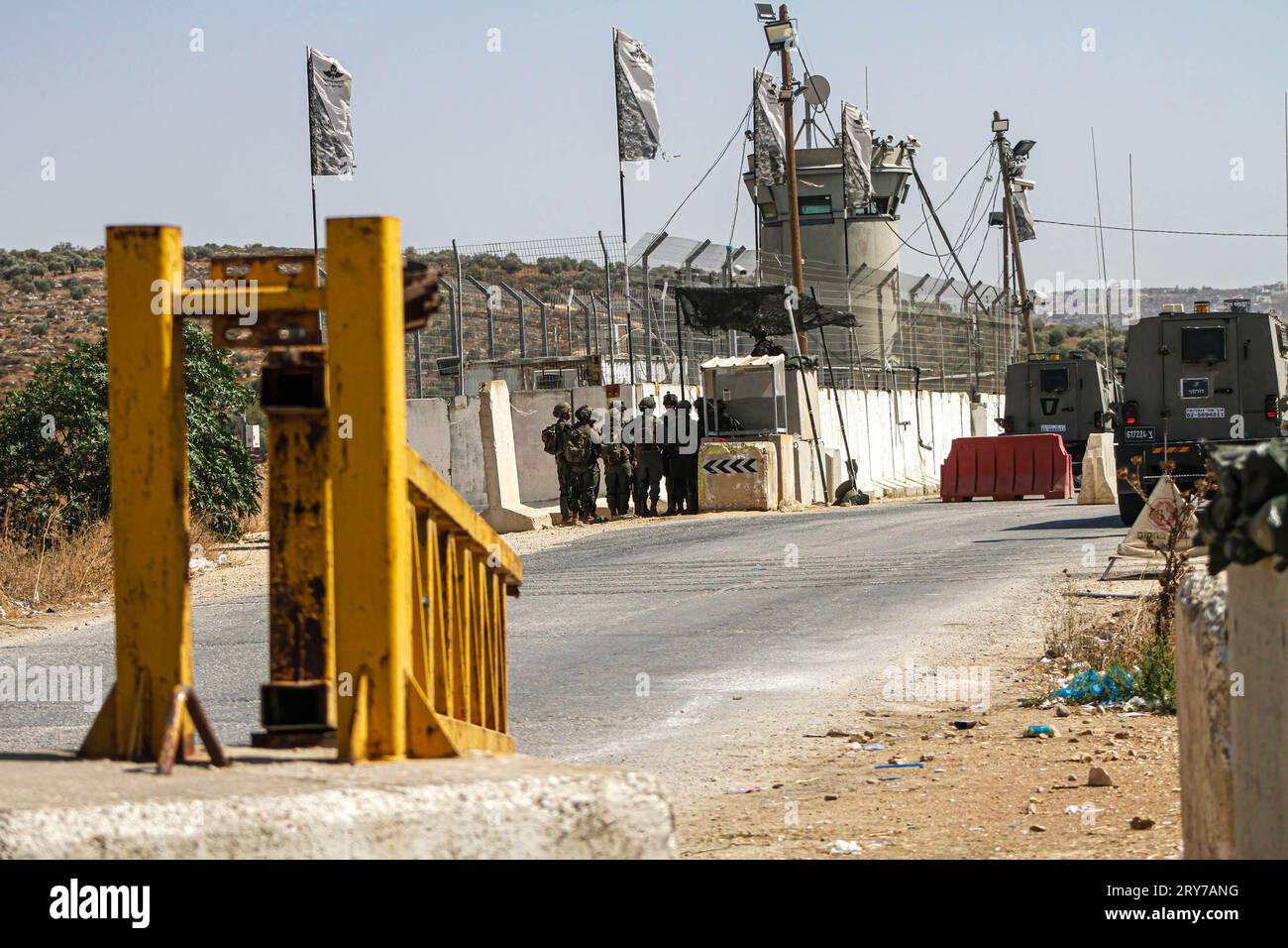 Israeli soldiers stand alert around an Israeli checkpoint near the ...