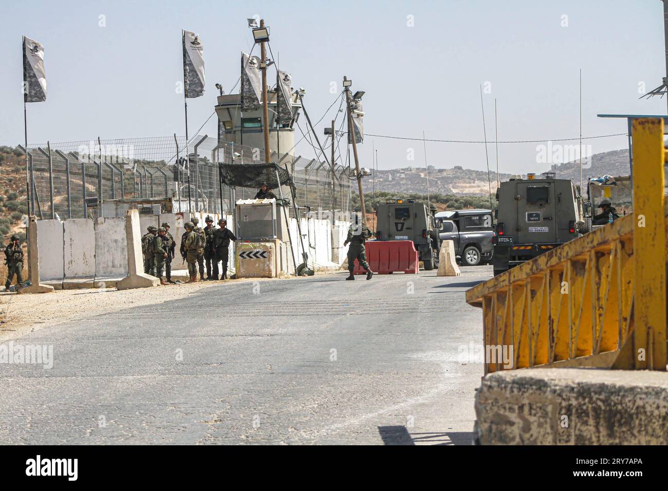 Israeli soldiers stand alert around an Israeli checkpoint near the ...