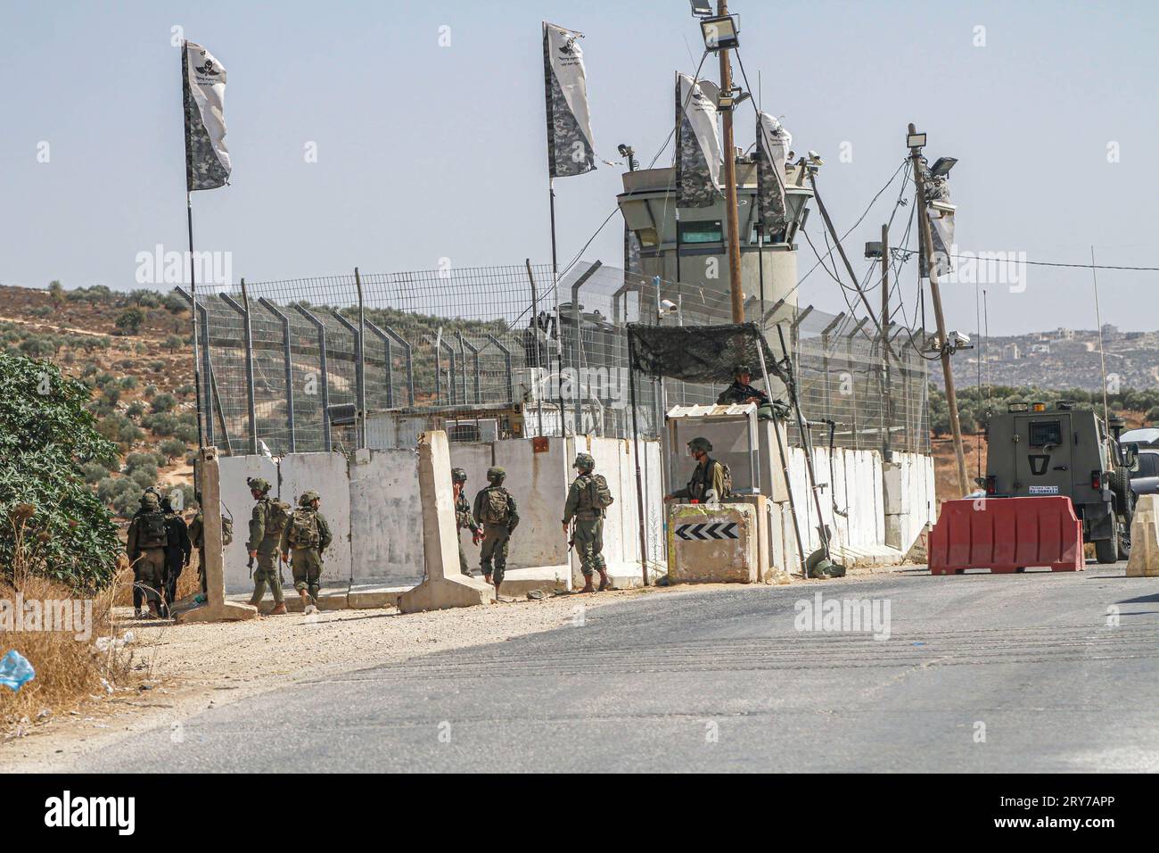 Israeli soldiers stand alert around an Israeli checkpoint near the ...